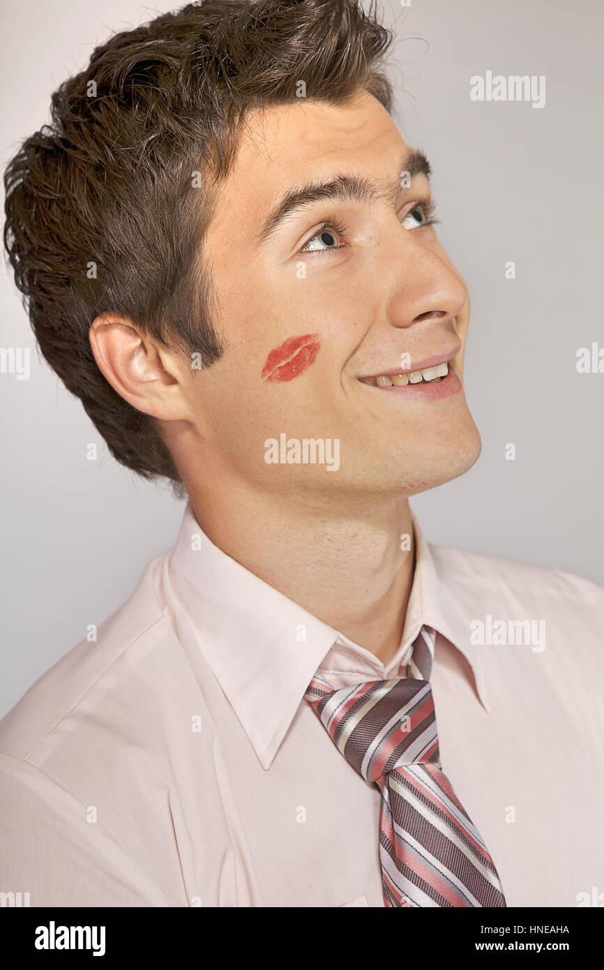 Young Caucasian Businessman With Lipstick Kiss Mark On His Cheek Stock