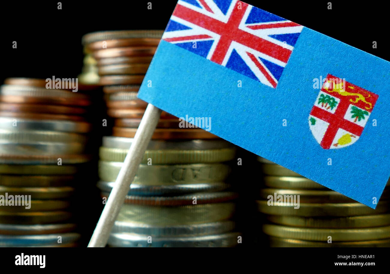 Fiji flag waving with stack of money coins macro Stock Photo - Alamy