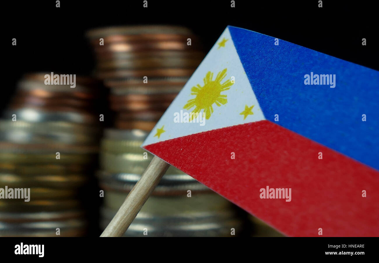 Philippines flag waving with stack of money coins macro Stock Photo - Alamy
