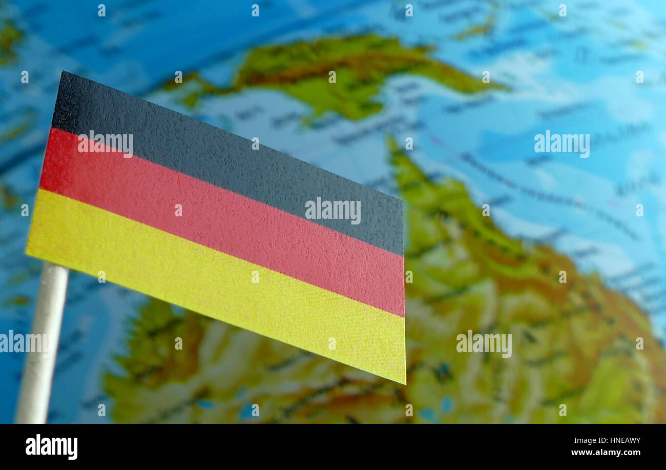 German flag with a globe map as a background macro Stock Photo - Alamy
