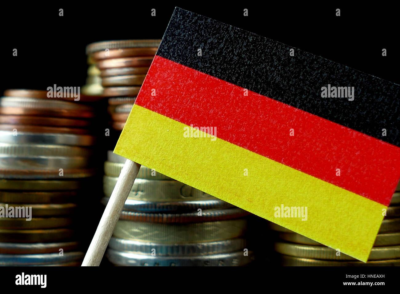 German flag waving with stack of money coins macro Stock Photo - Alamy