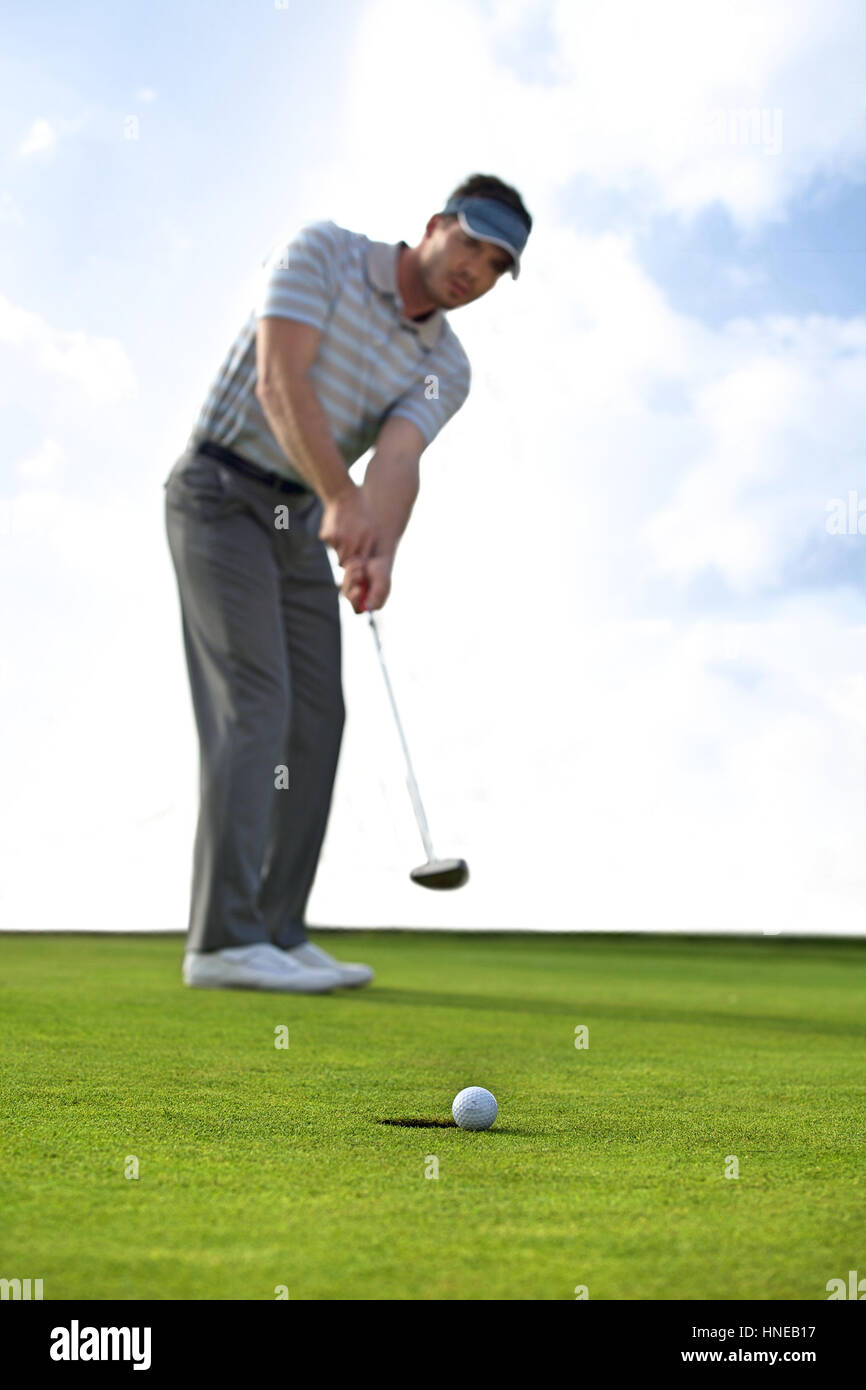 Young man playing golf Stock Photo - Alamy