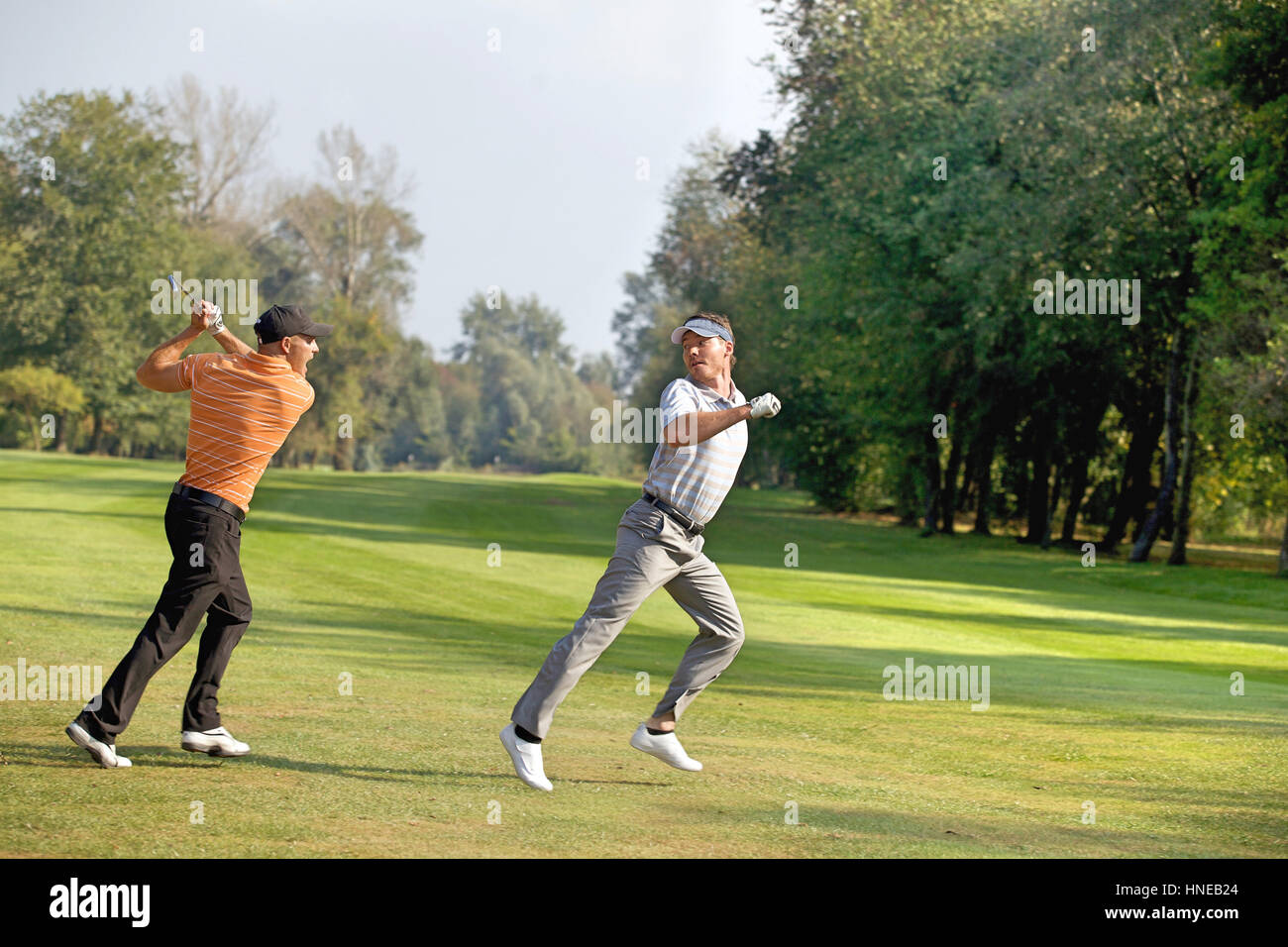 Friends having fun in golf course Stock Photo - Alamy