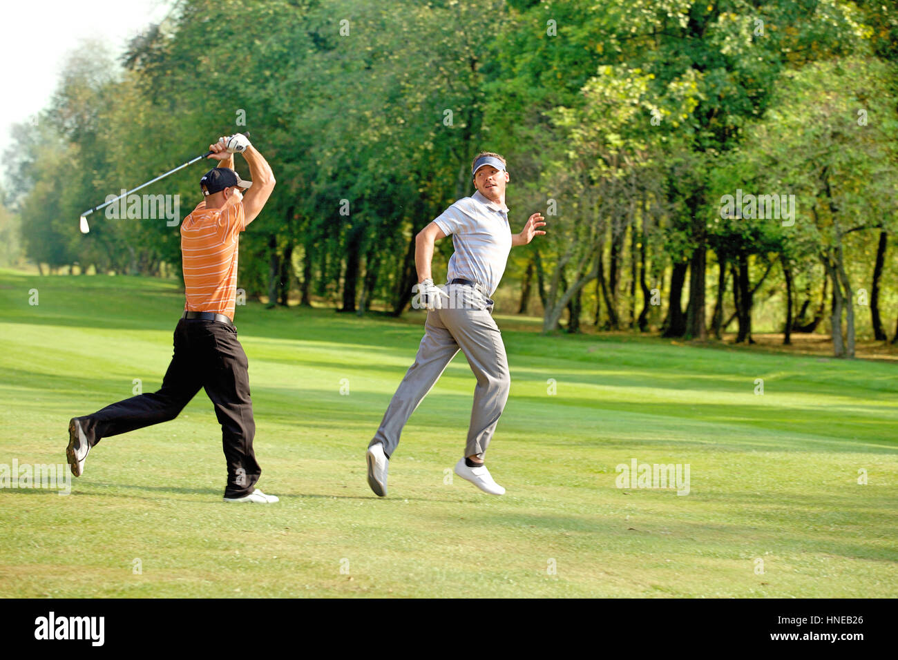 Friends having fun in golf course Stock Photo - Alamy