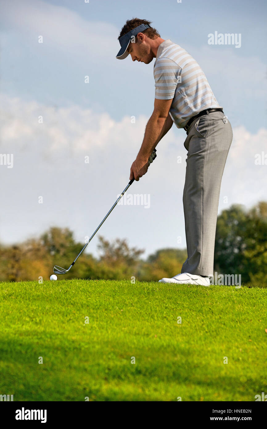 Young man playing golf Stock Photo - Alamy