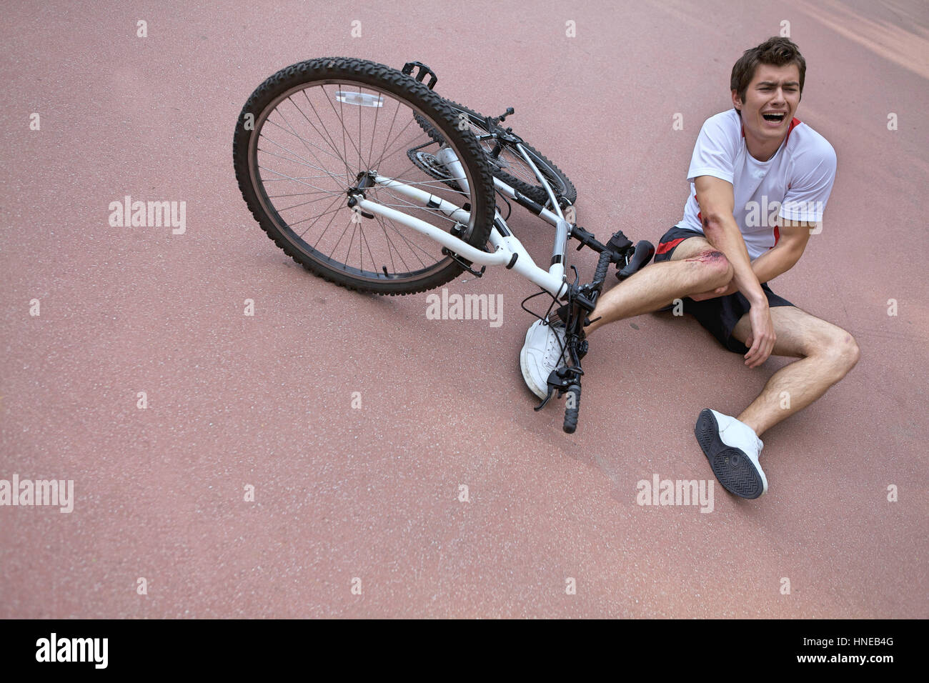 Young man injured during riding a bike Stock Photo - Alamy