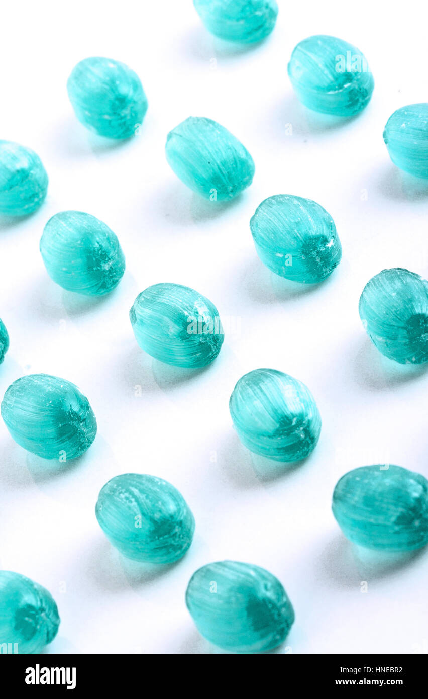 Blue candies on white background Stock Photo - Alamy