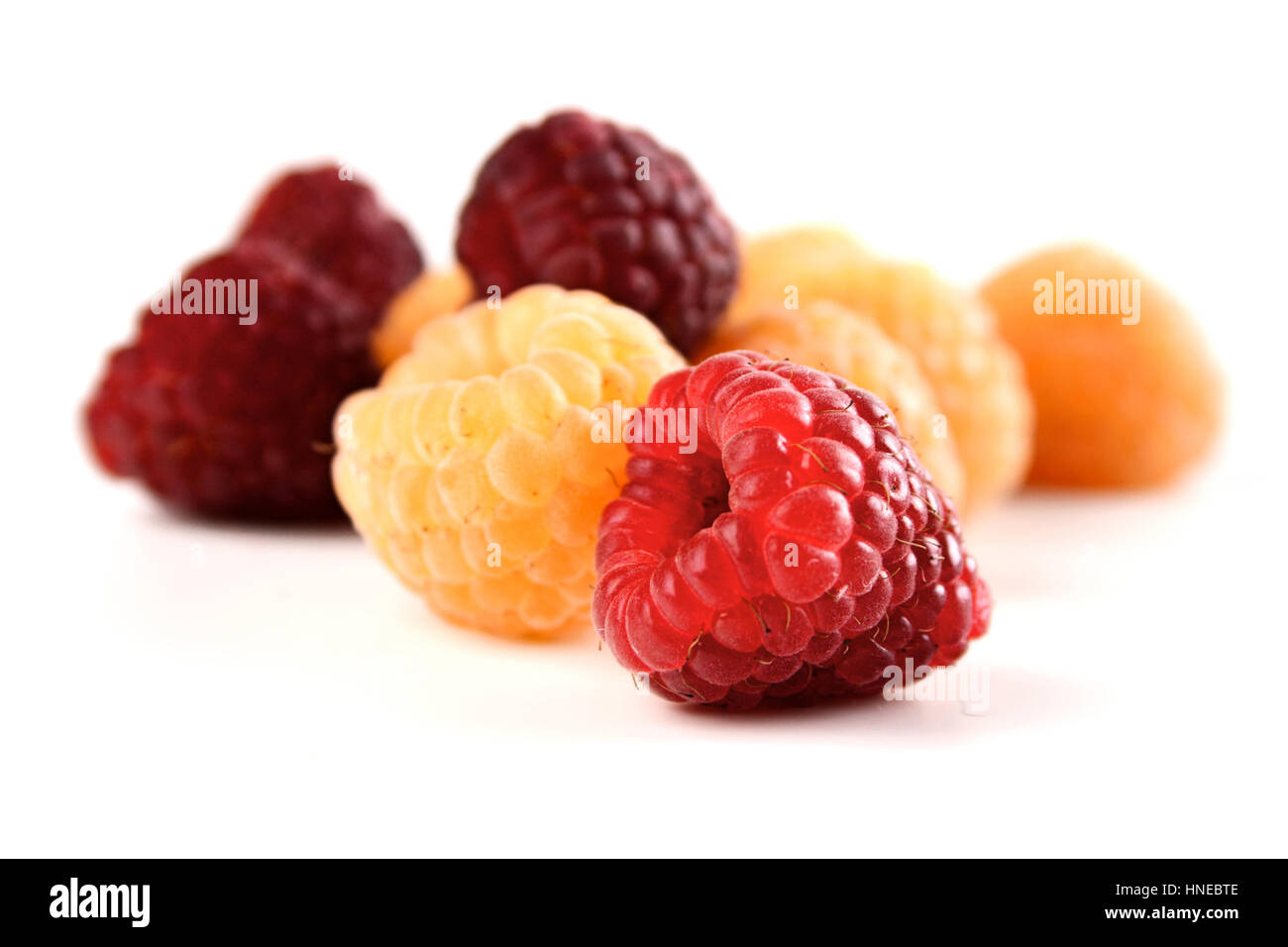 Red and yellow raspberries on white background Stock Photo - Alamy