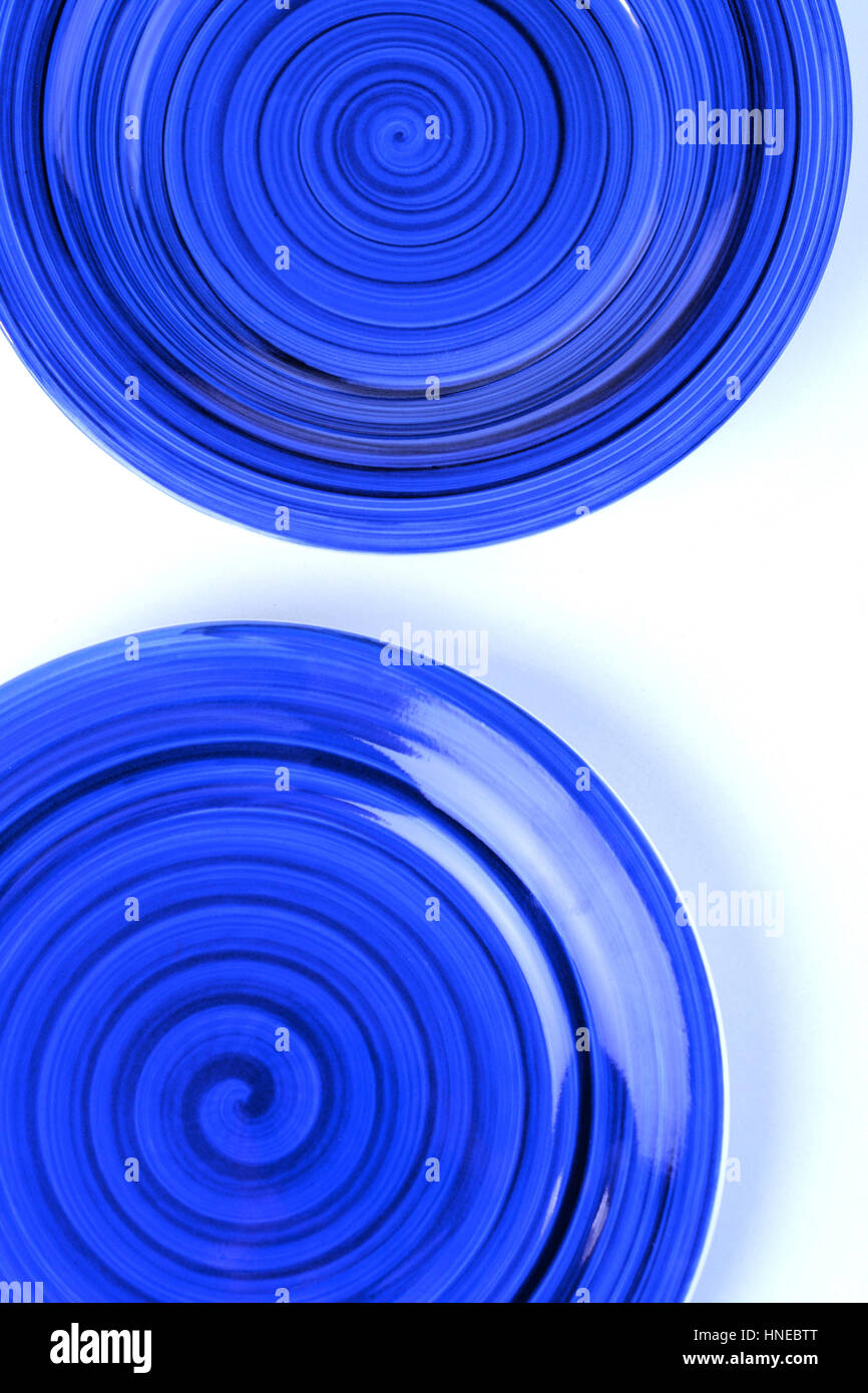 Blue plates on white background Stock Photo - Alamy