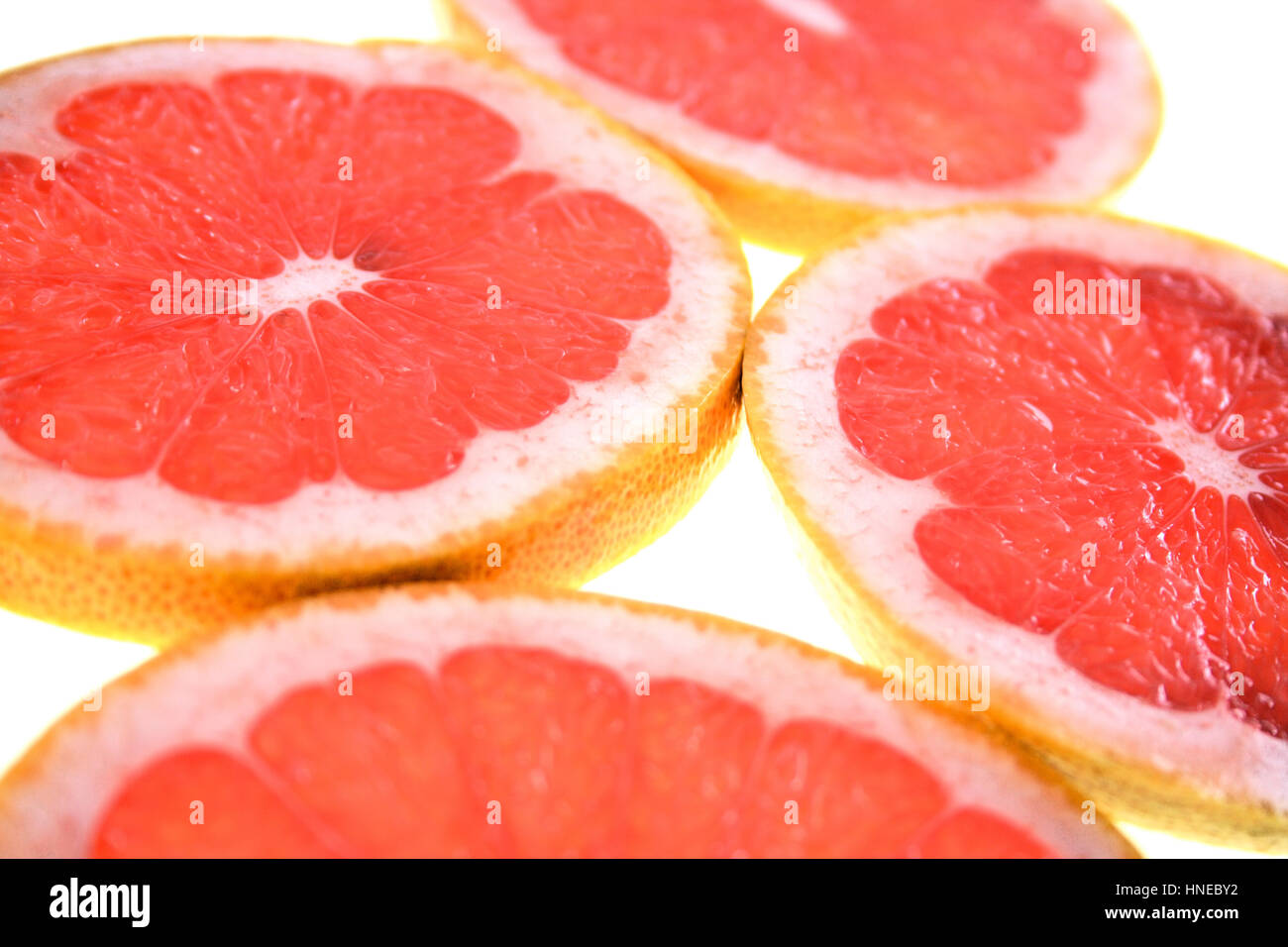 Closeup of sliced grapefruit on white background Stock Photo - Alamy