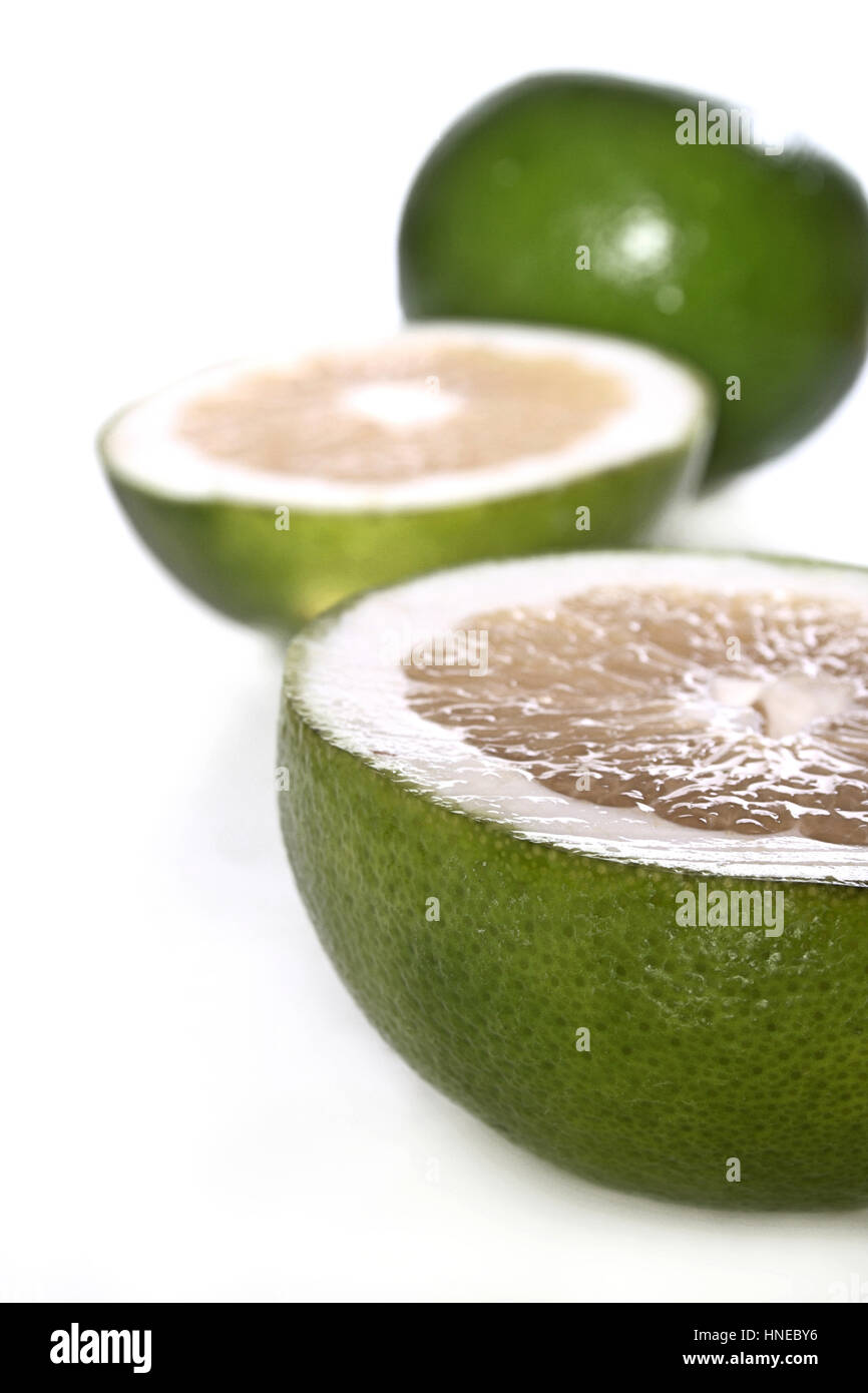Green grapefruits on white background Stock Photo - Alamy