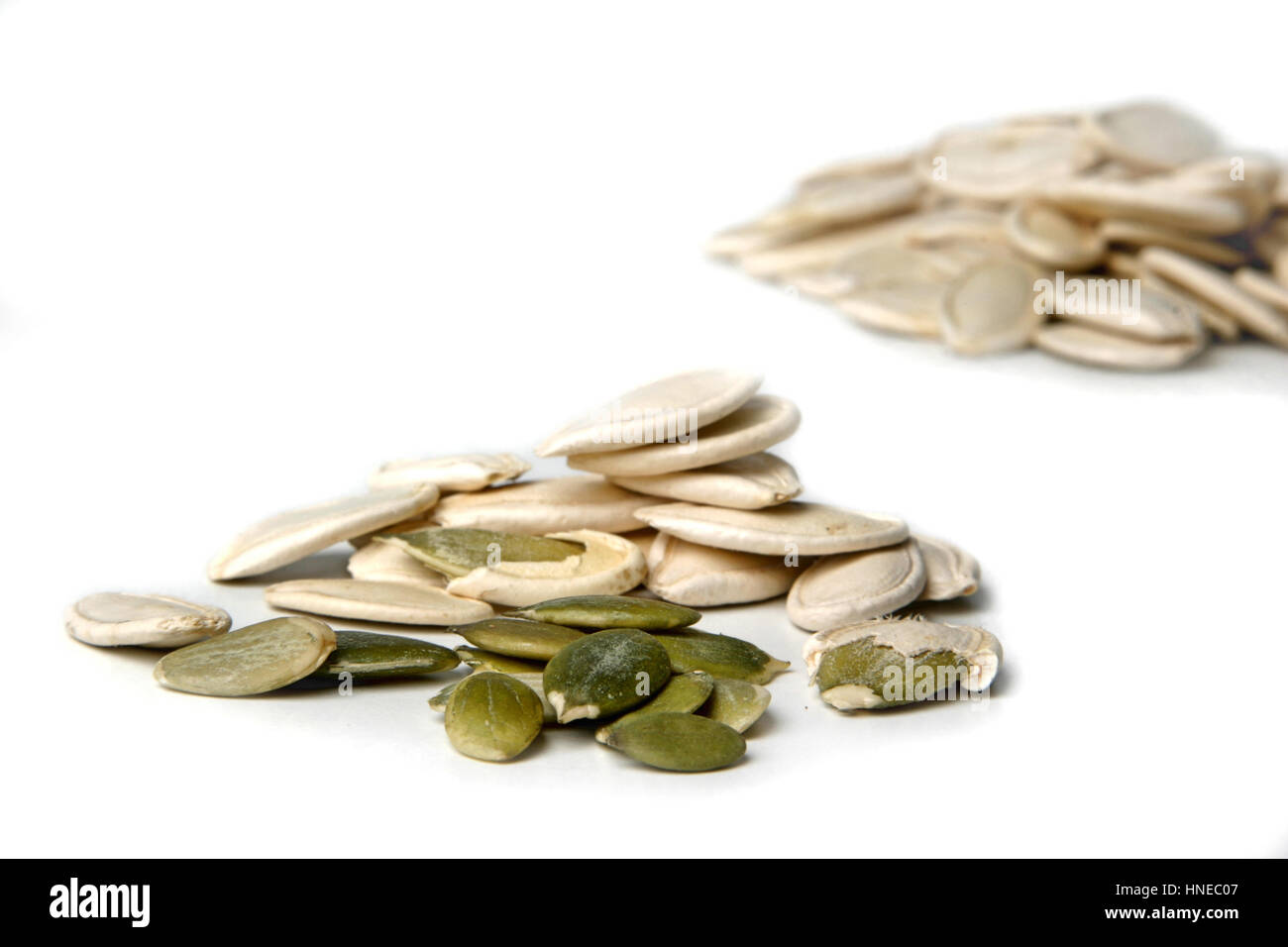 Pumpkin seeds on white background Stock Photo - Alamy