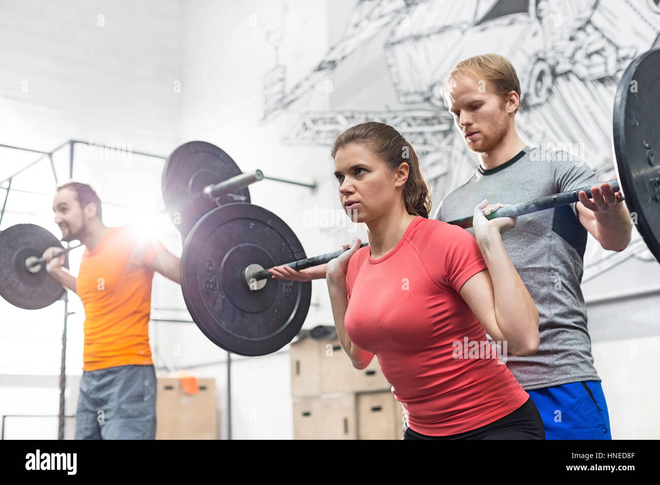 People lifting barbells in crossfit gym Stock Photo - Alamy