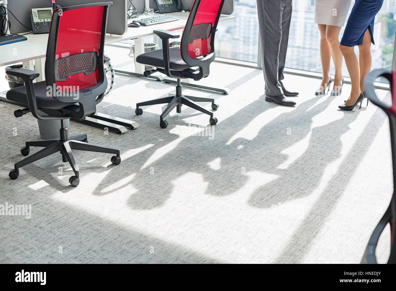Low section of businesspeople standing in office Stock Photo - Alamy