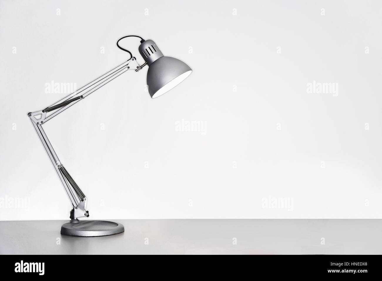 Desk lamp on table over white background Stock Photo - Alamy