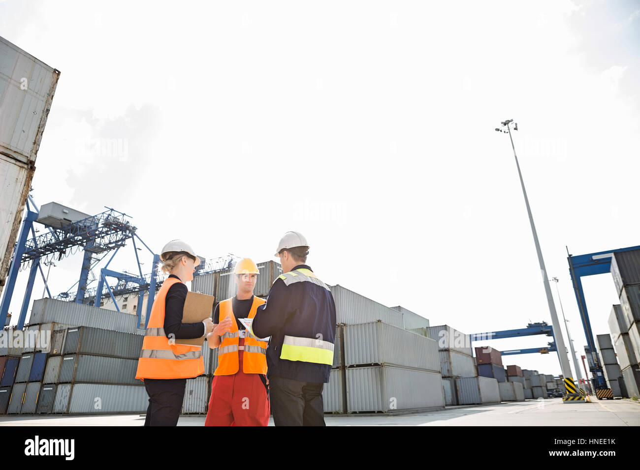 Workers talking in shipping yard Stock Photo - Alamy