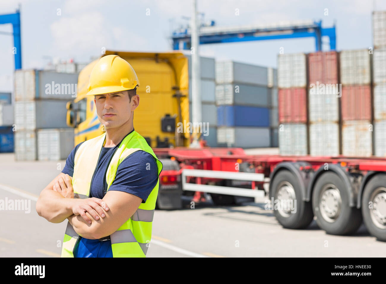 Portrait of confident mid adult man in shipping yard Stock Photo - Alamy