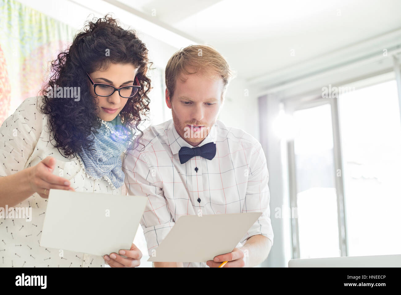 Businesspeople discussing over samples in creative office Stock Photo ...