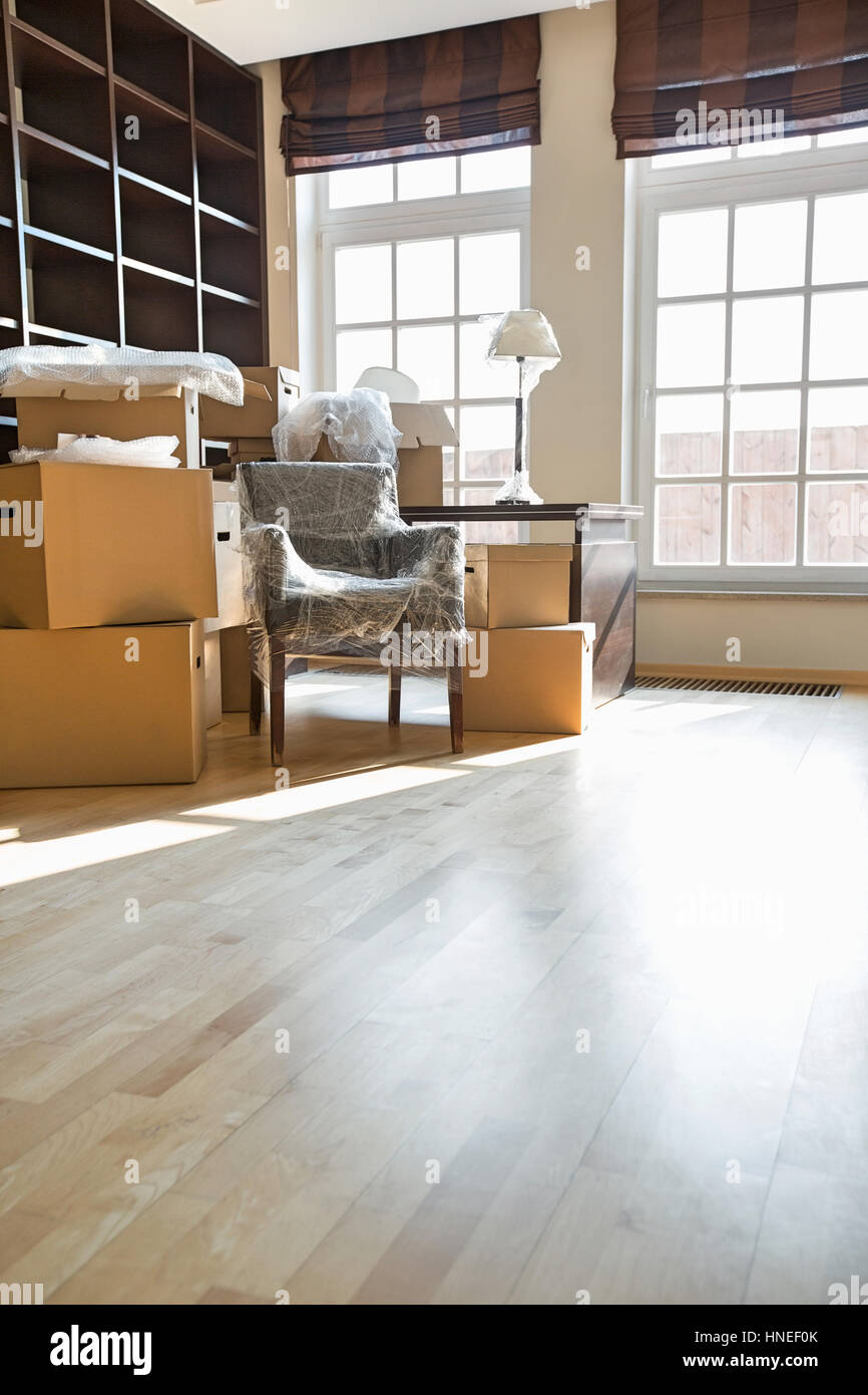 Cardboard boxes and furniture in new home Stock Photo - Alamy