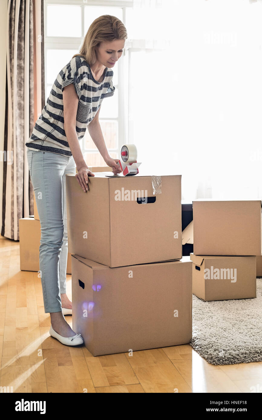 Woman packing cardboard box at home Stock Photo - Alamy