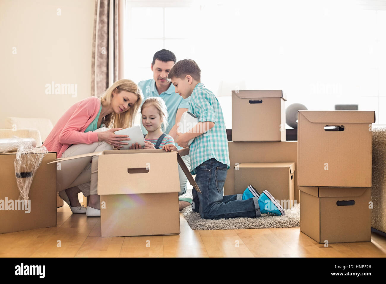 Mother son unpacking moving boxes hi-res stock photography and images ...
