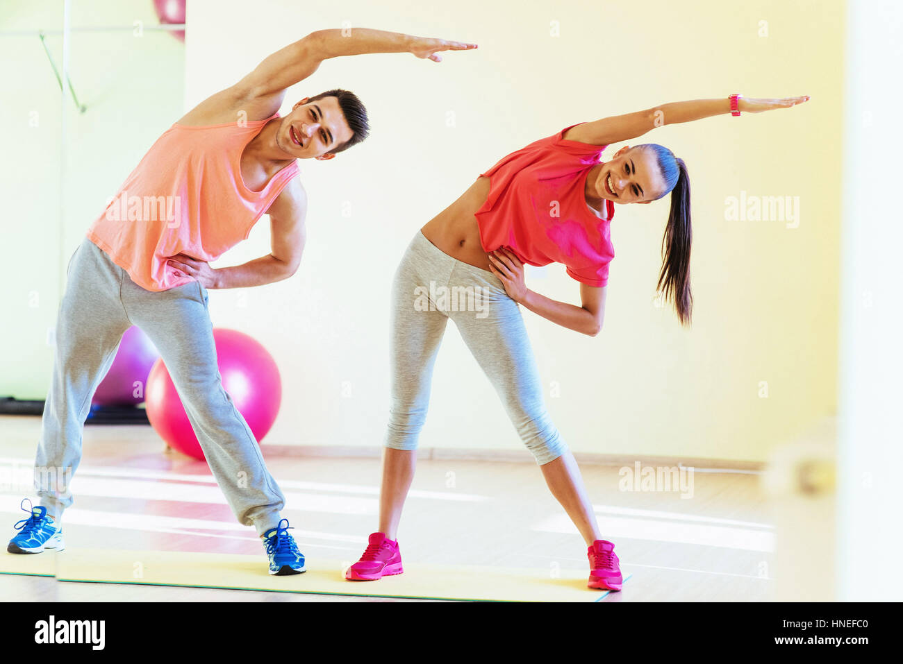 two young people in the gym doing exercises for fitness Stock Photo - Alamy