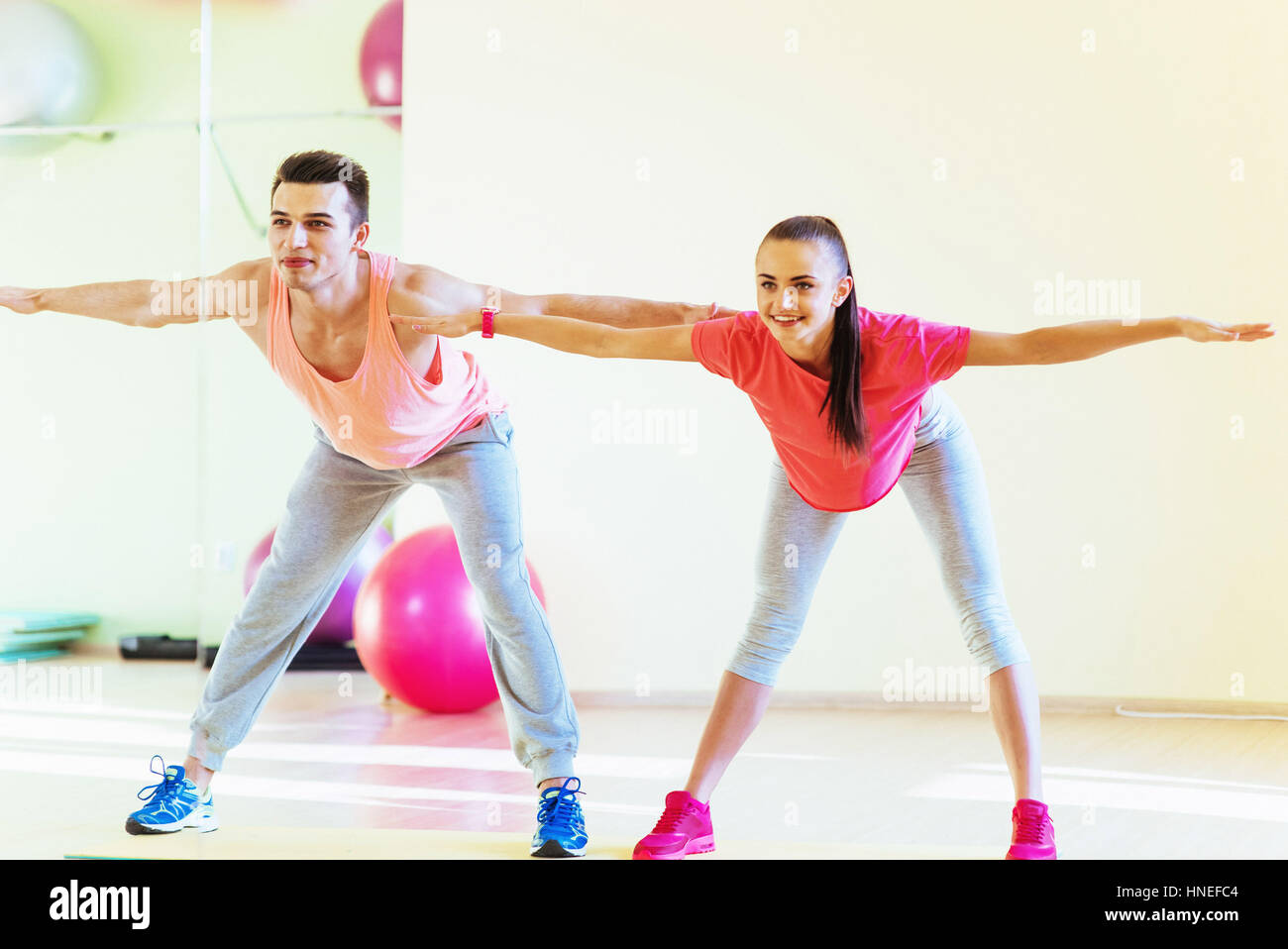 two young people in the gym doing exercises for fitness Stock Photo - Alamy