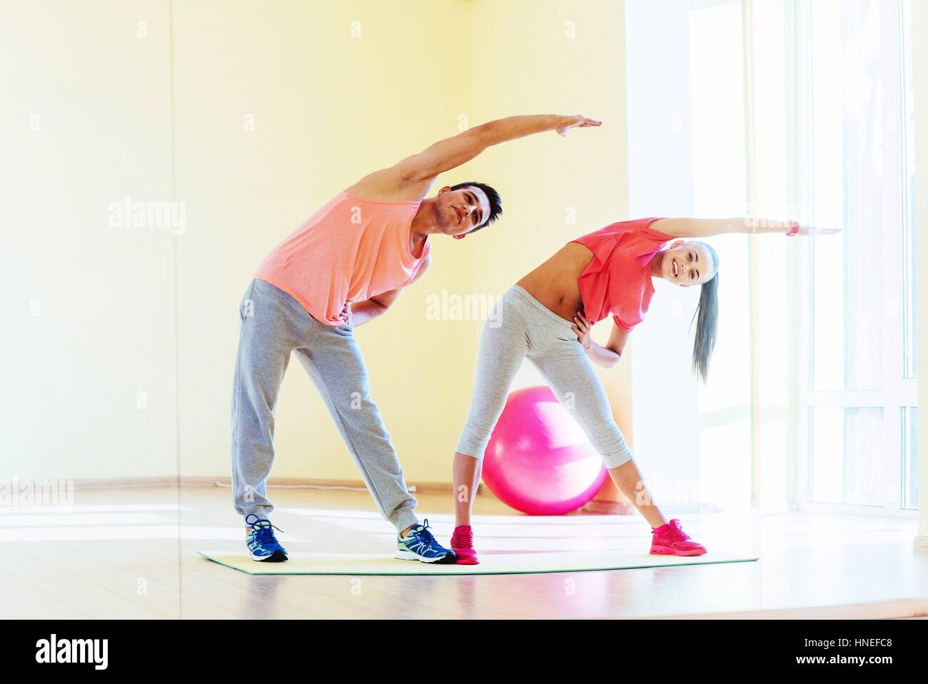 two young people in the gym doing exercises for fitness Stock Photo - Alamy