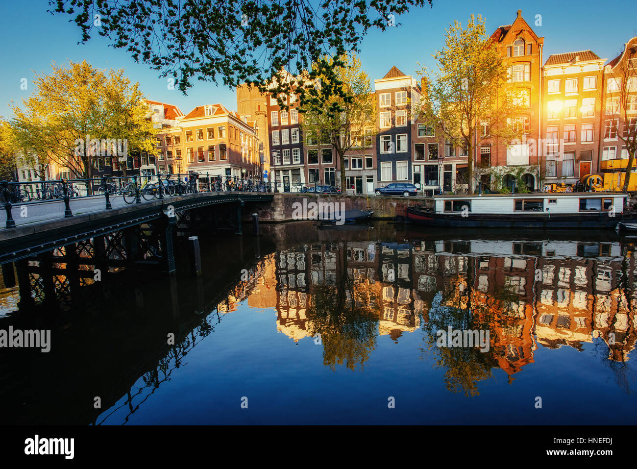 Beautiful sunset in Amsterdam. Highlighting sun buildings and bo Stock ...