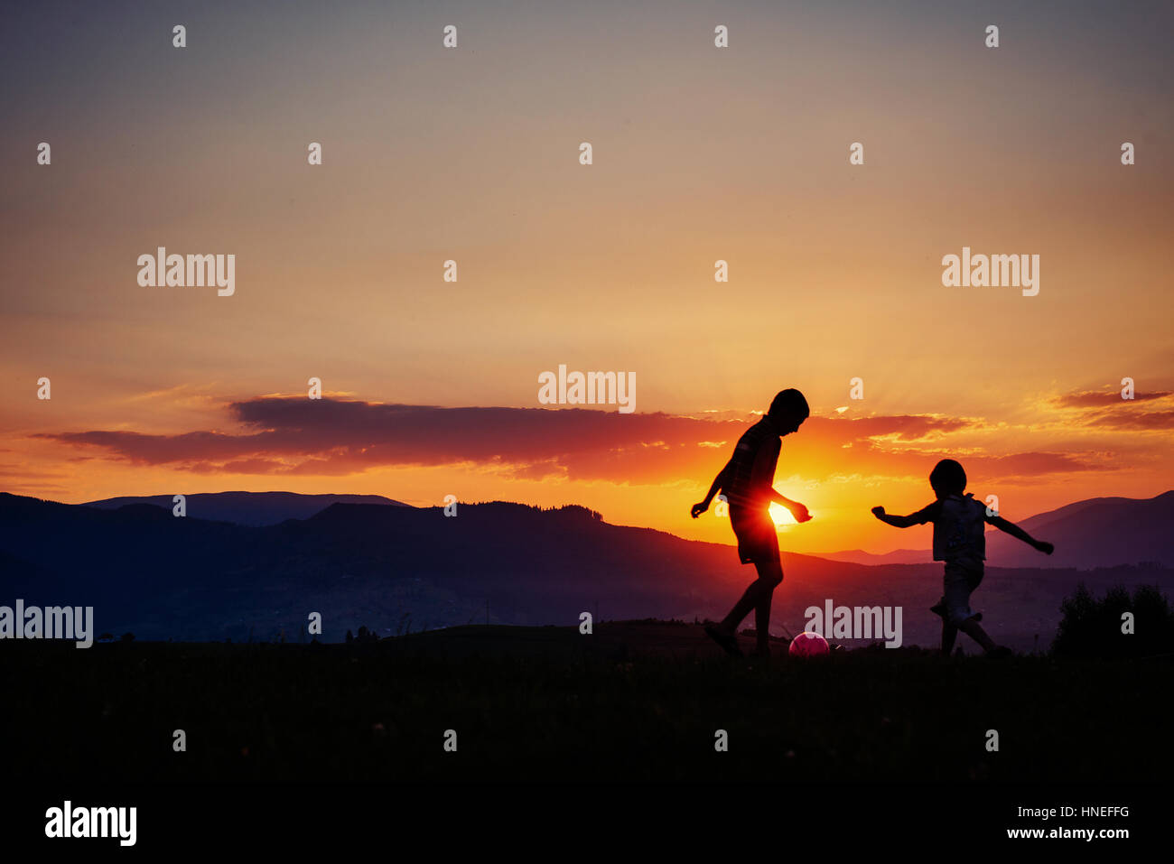 Children playing at sunset Stock Photo - Alamy