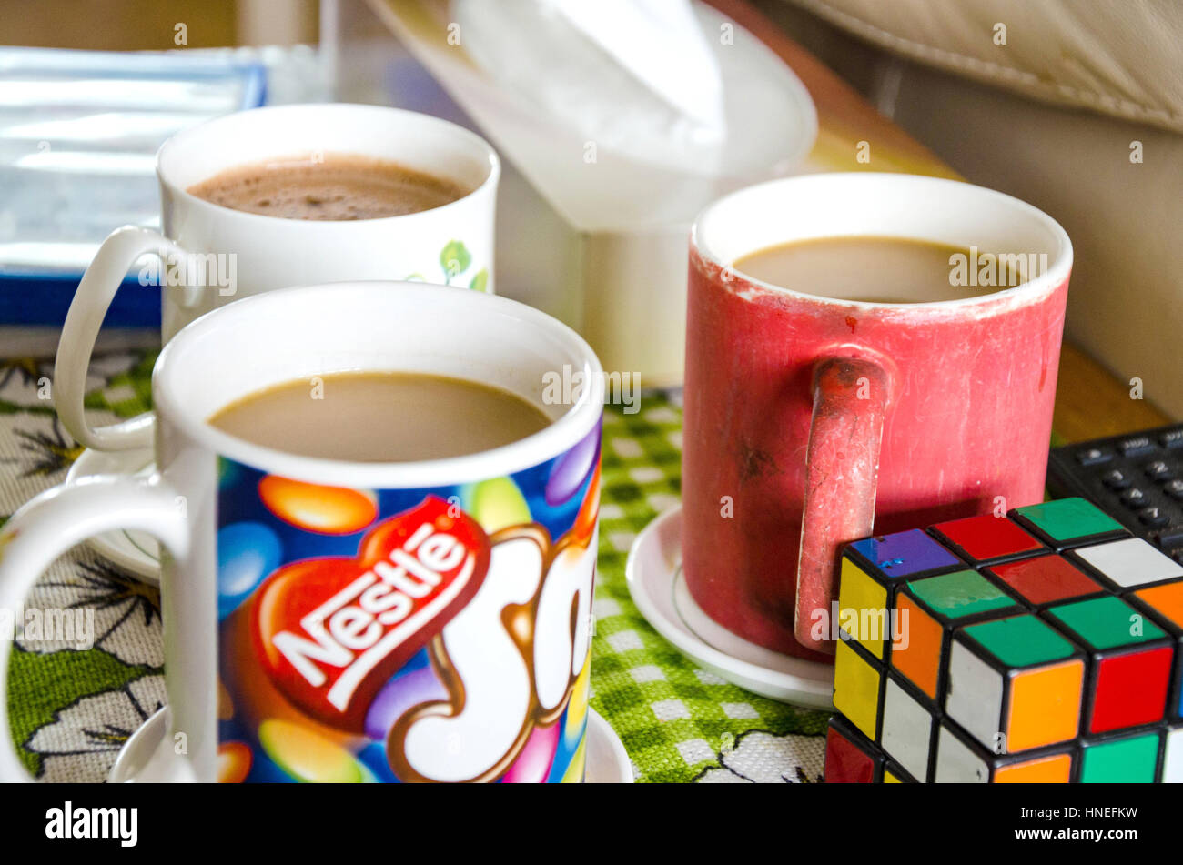 Mugs of coffee on a side table Stock Photo - Alamy