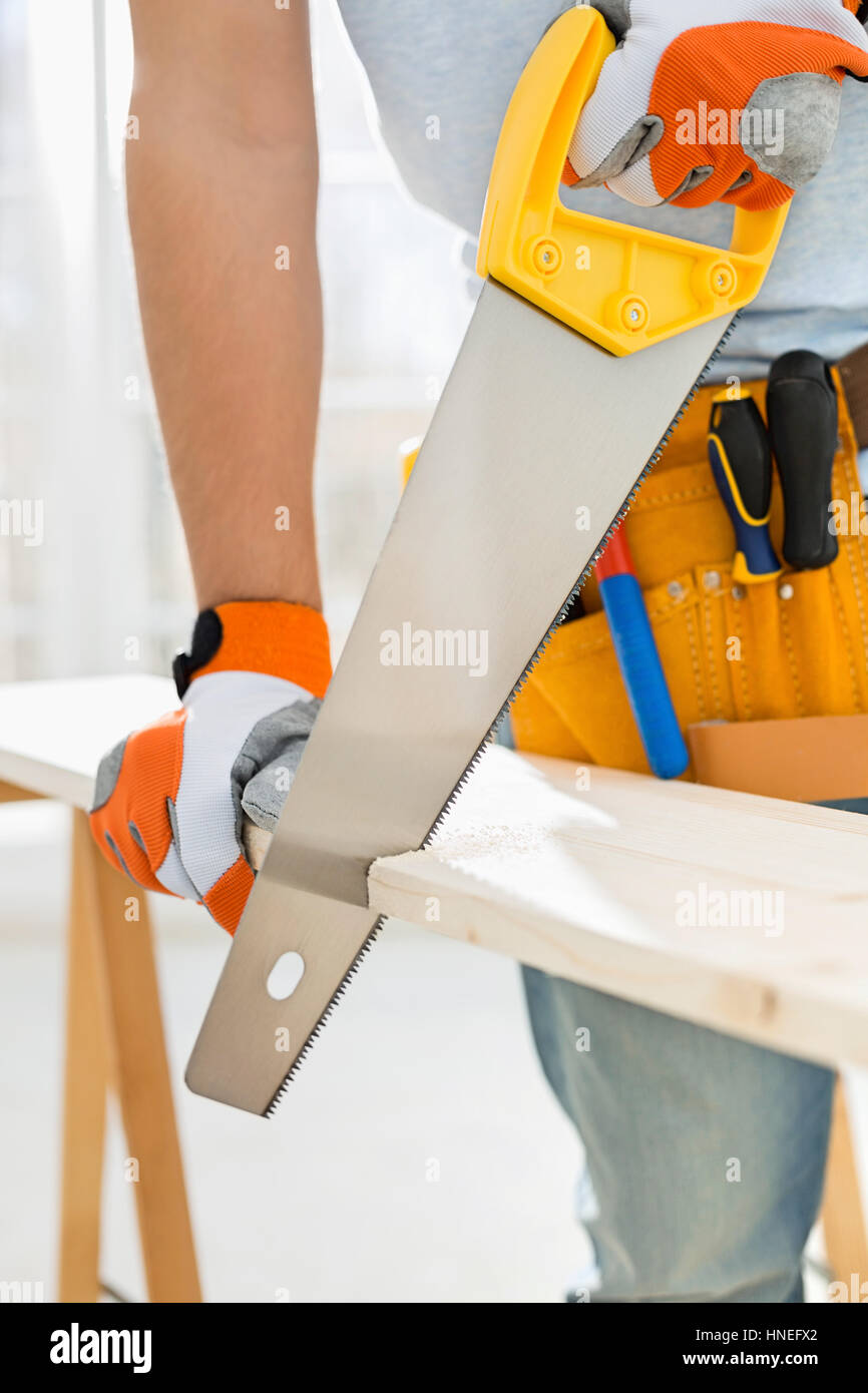 Man sawing wood hi-res stock photography and images - Alamy