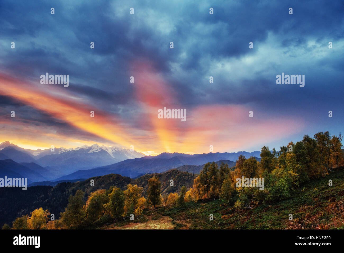 Sunset over snow-capped mountain peaks Stock Photo - Alamy