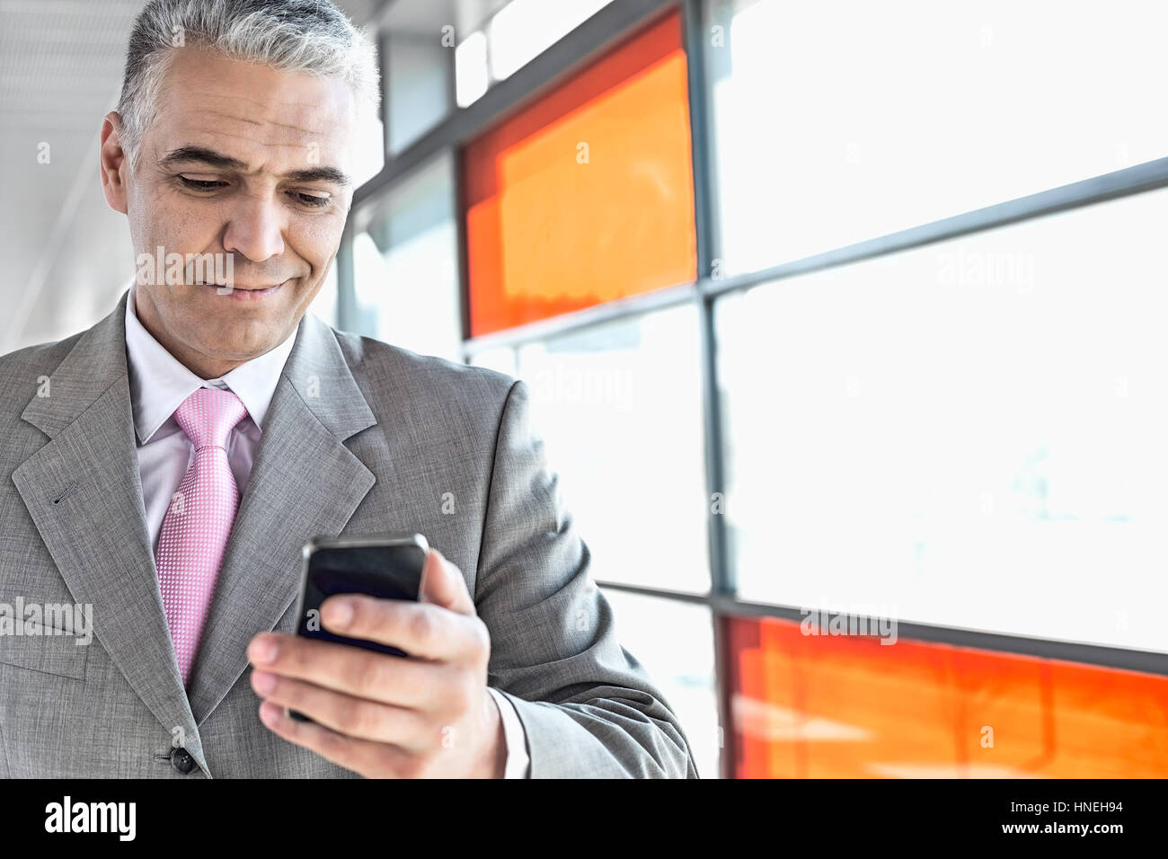 Middle aged businessman using cell phone at railroad station Stock ...