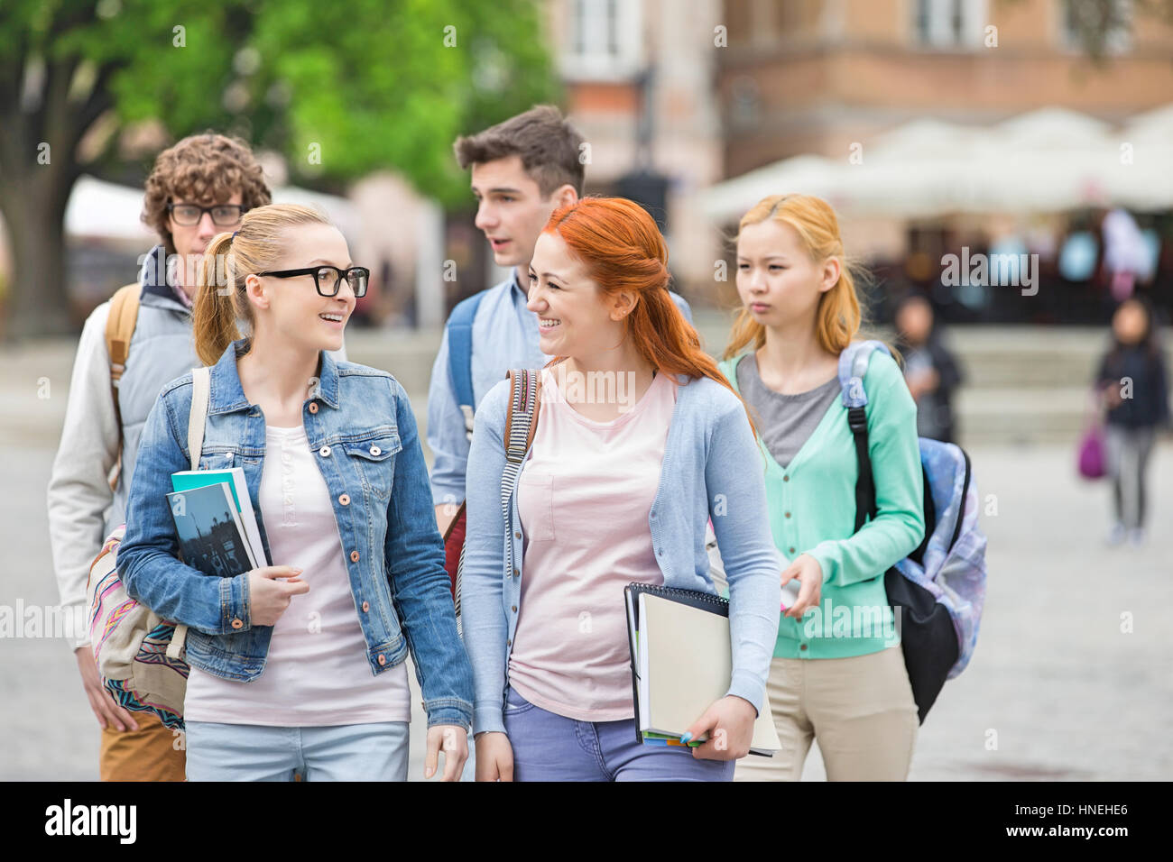 Group of college friends walking outdoors Stock Photo - Alamy