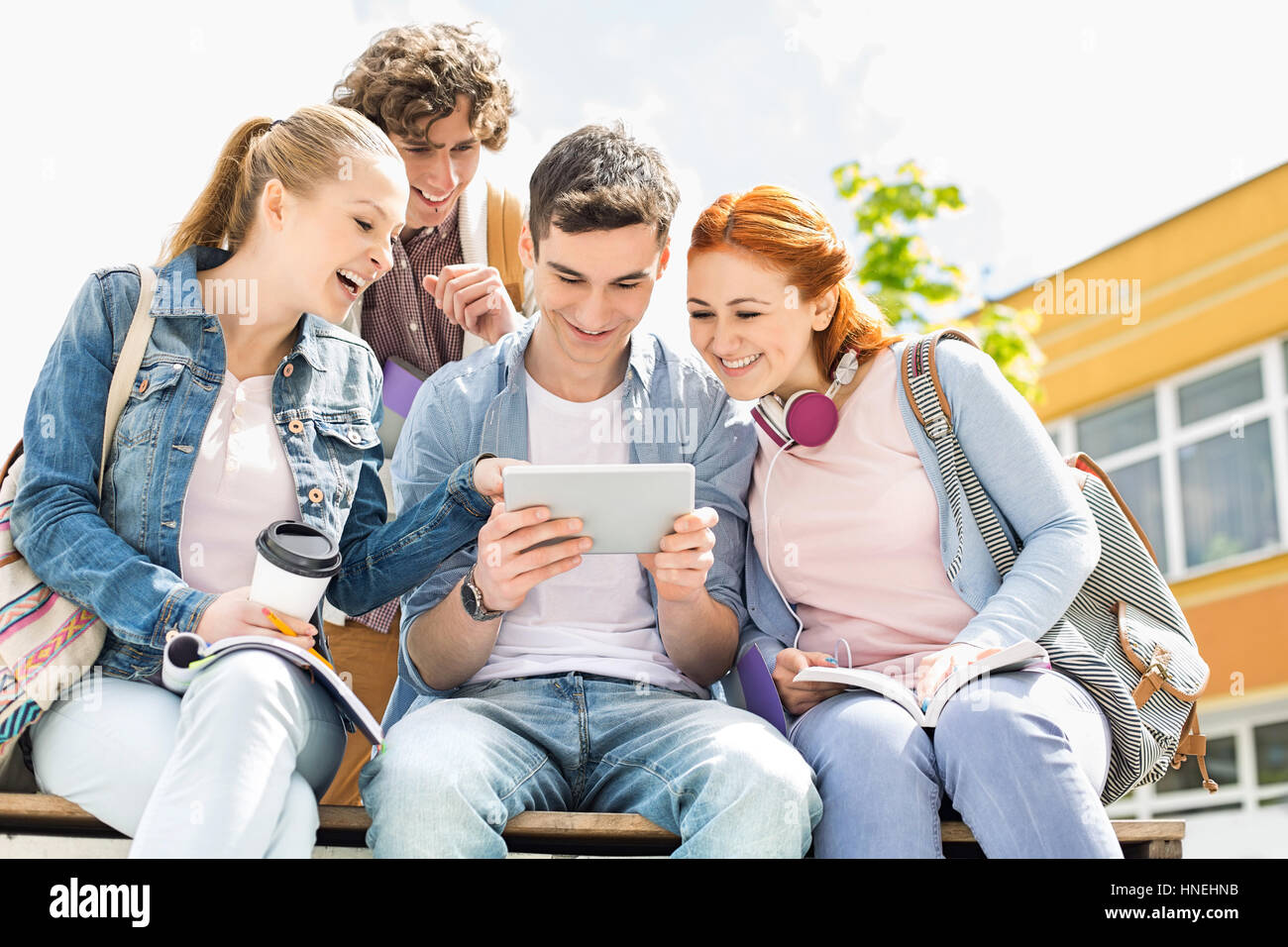 Young students using digital tablet at college campus Stock Photo - Alamy