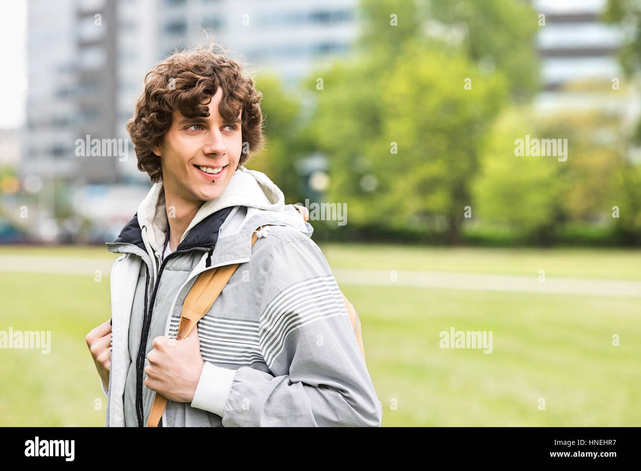 Smiling young male university student at college campus Stock Photo - Alamy