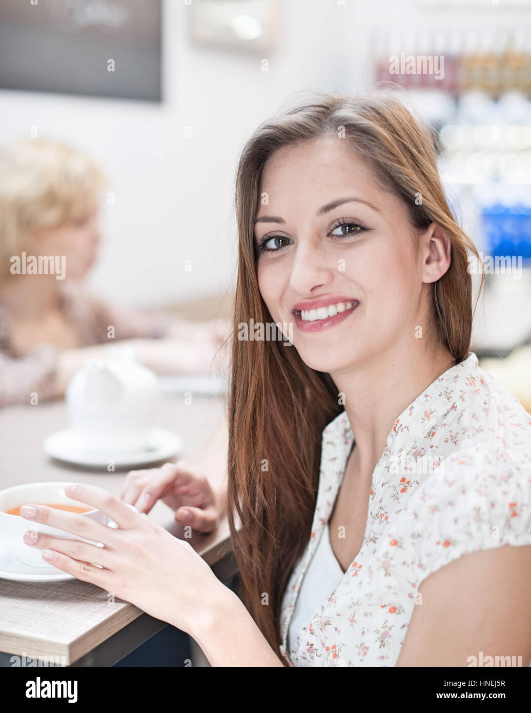 Portrait of beautiful young woman having coffee at table in cafe Stock ...
