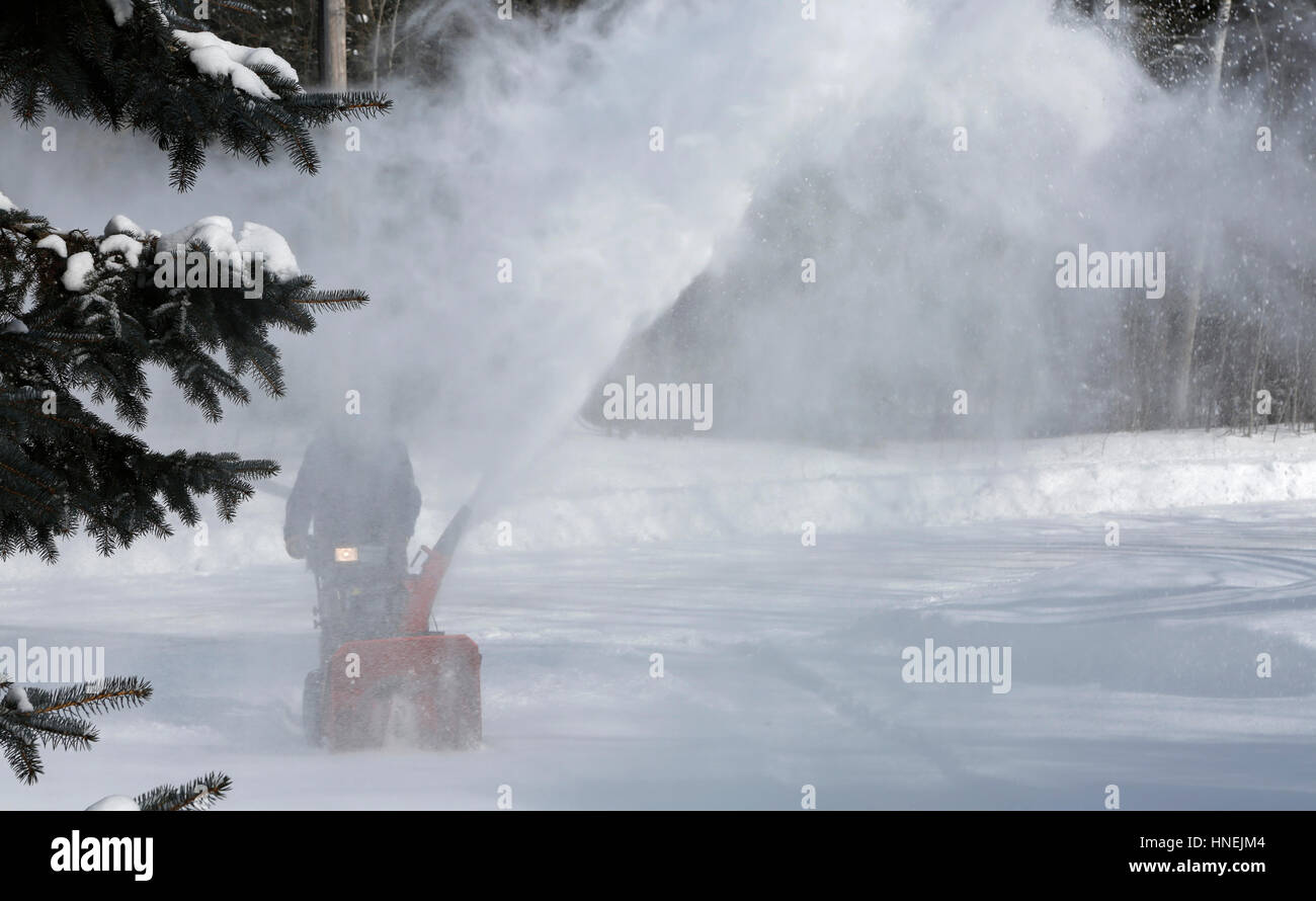 Winter blizzard: Clearing Snow with a Snow Blower Stock Photo - Alamy