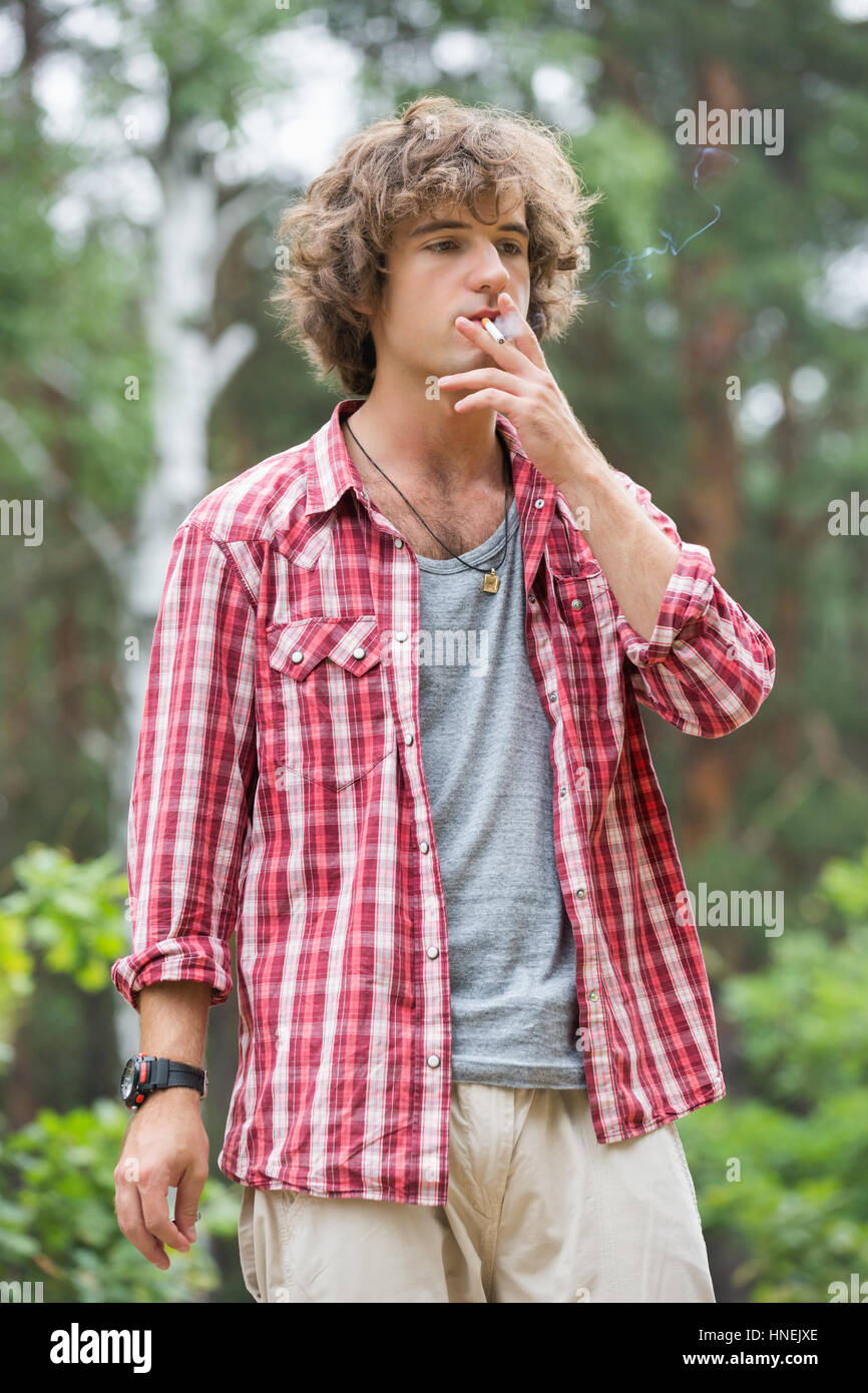 Man smoking cigarette in the forest hi-res stock photography and images ...