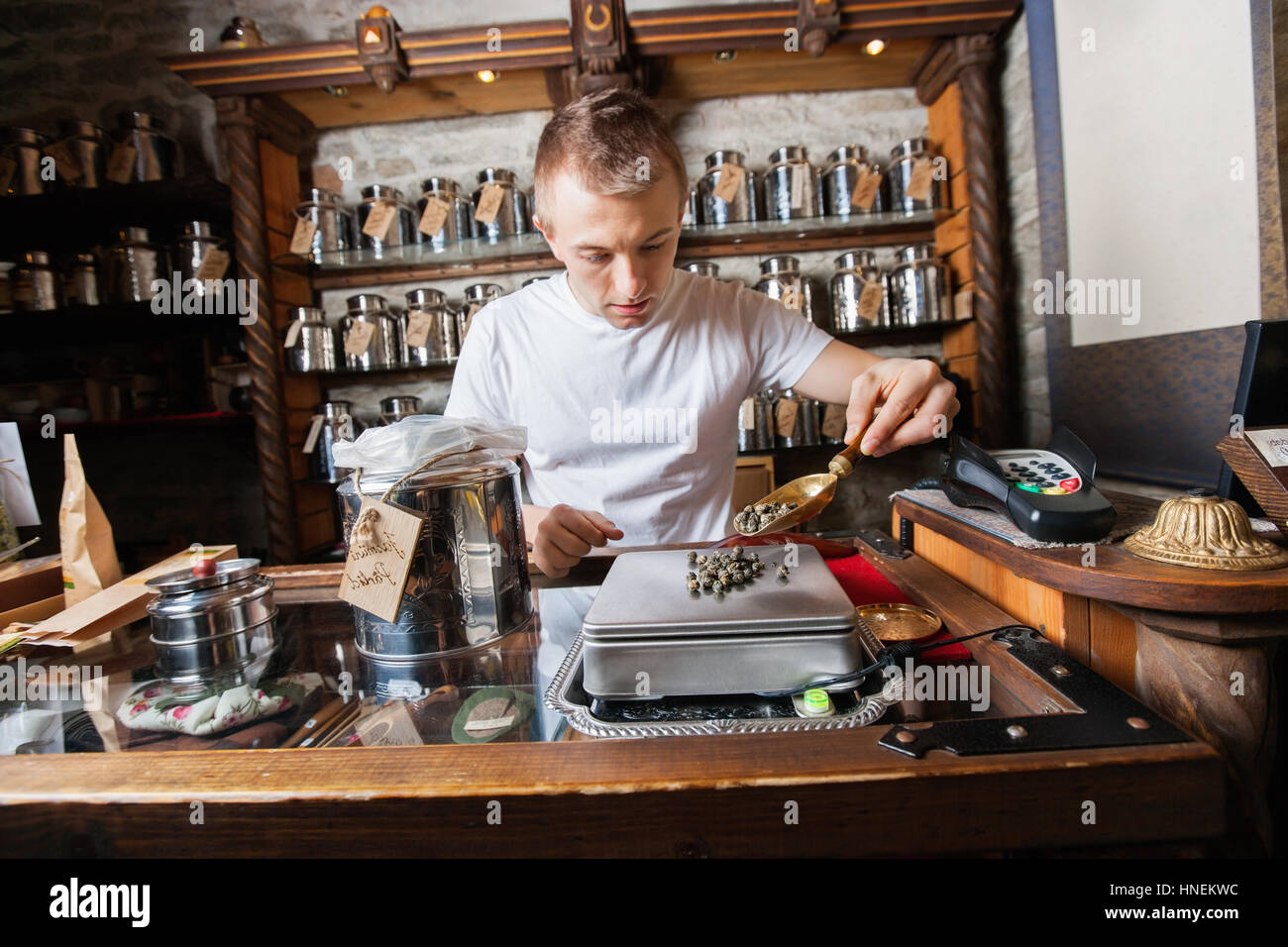 Male owner measuring ingredient on weight scale in tea store Stock ...