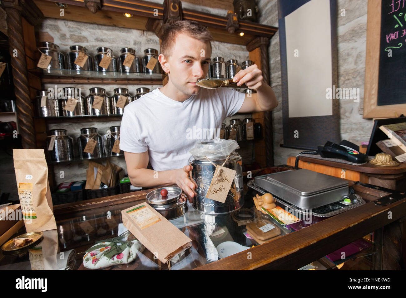 Salesman smelling tea in store Stock Photo - Alamy