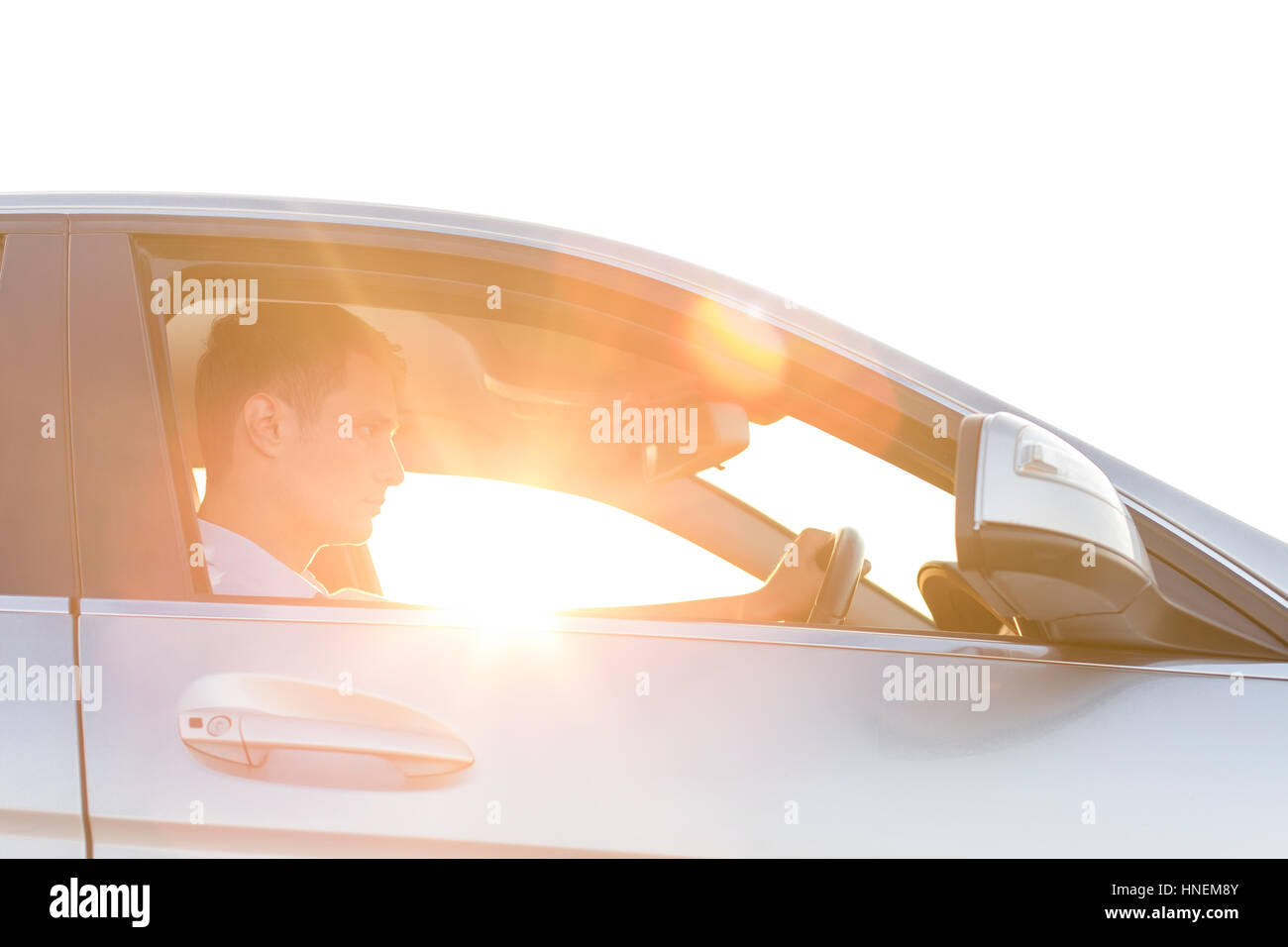 Side view of young man driving car Stock Photo - Alamy