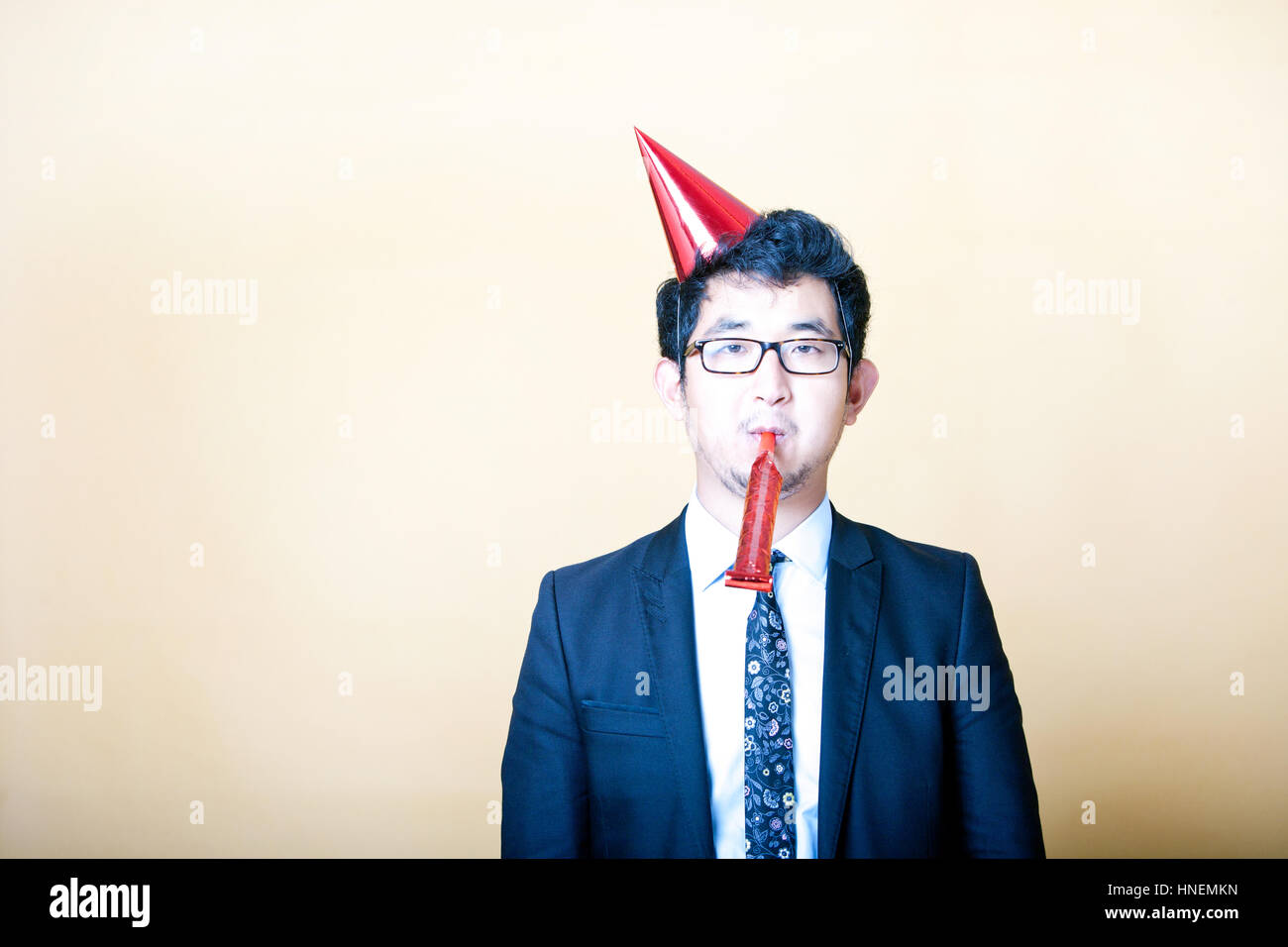 Asian business man wearing party hat Stock Photo - Alamy