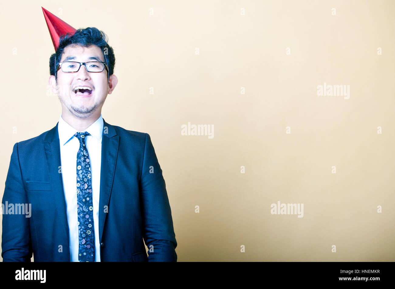 Asian business man wearing party hat Stock Photo - Alamy