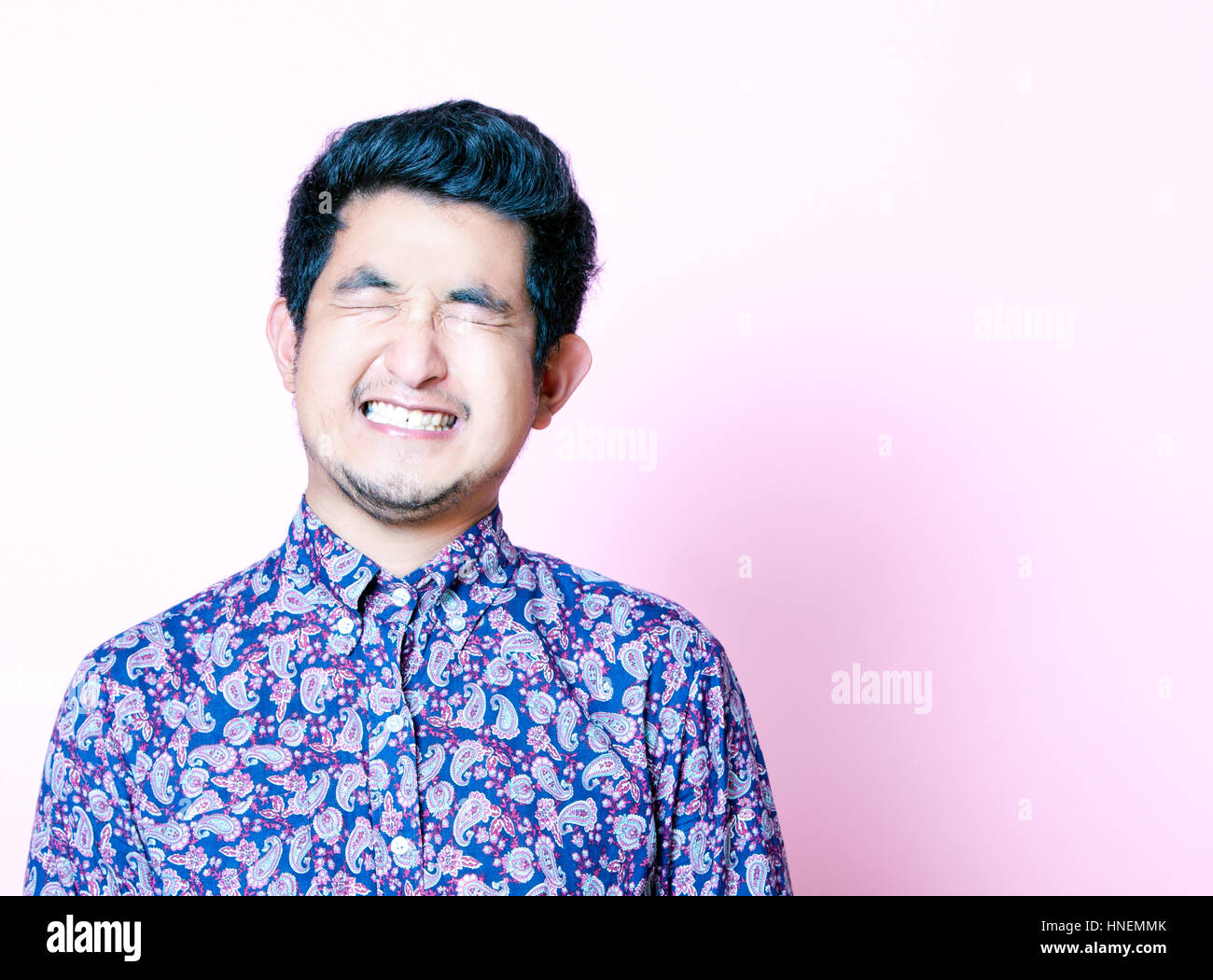 Young Geeky Asian Man in colorful shirt laughing on the phone Stock ...