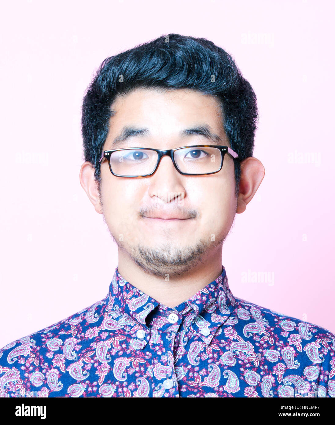 Young Geeky Asian Man in colorful shirt wearing glasses Stock Photo - Alamy