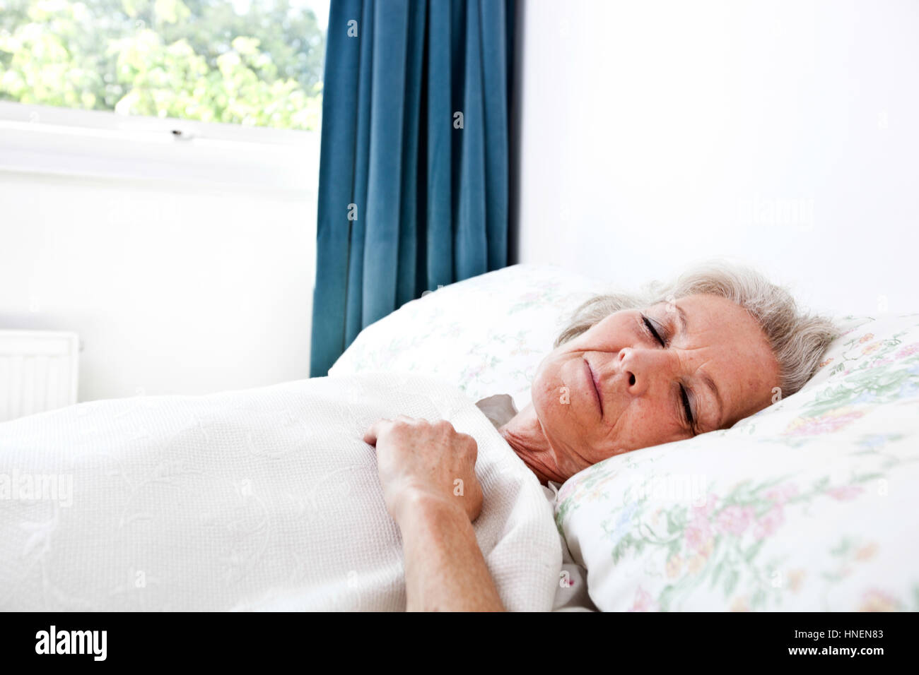 Senior woman sleeping in bedroom at home Stock Photo - Alamy