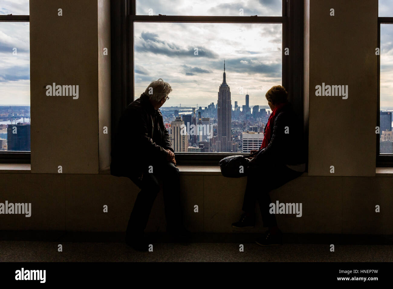 tourists looking to Empire State Building through the window editorial ... tourists looking to Empire State Building through the window editorial ...