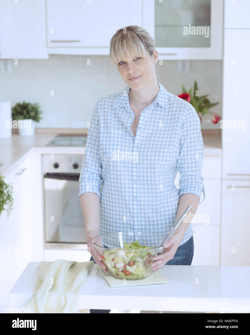 Young woman making salad Stock Photo - Alamy